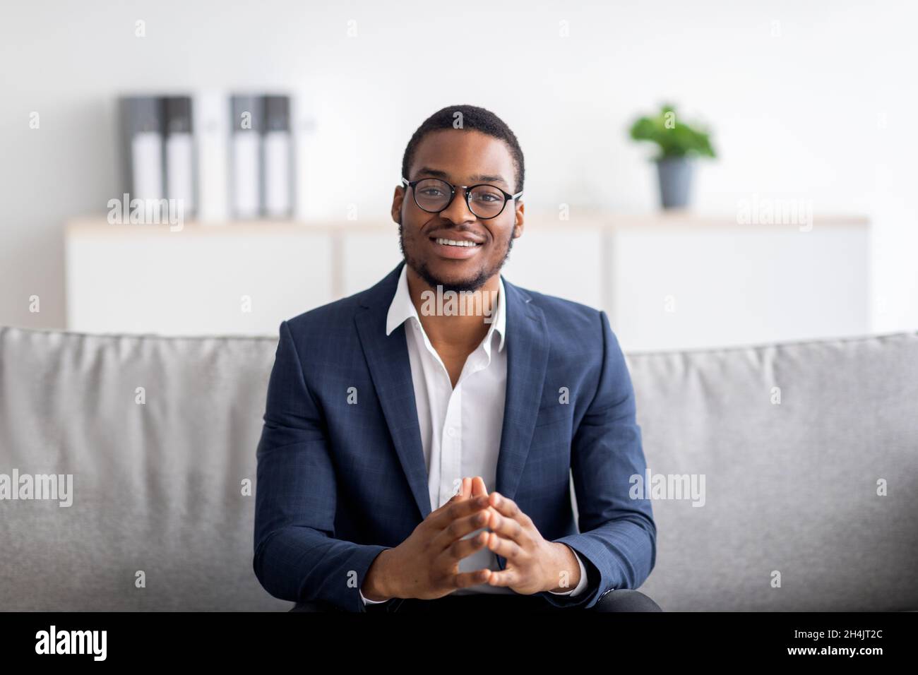 Portrait of cheerful young black psychologist smiling at camera ...