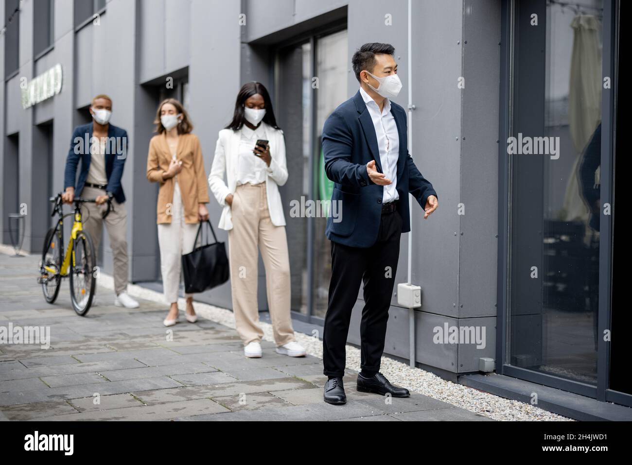 Multiracial businesspeople waiting in queue on city street Stock Photo ...
