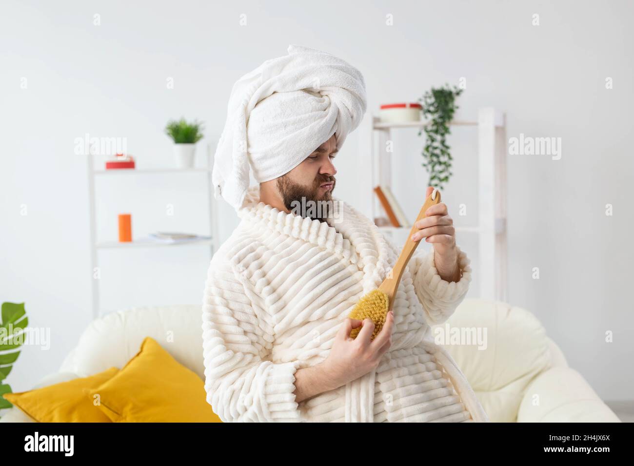 Funny Handsome Man Pretends To Play On Massage Brush As A Guitar Fun Spa And Humor Concept