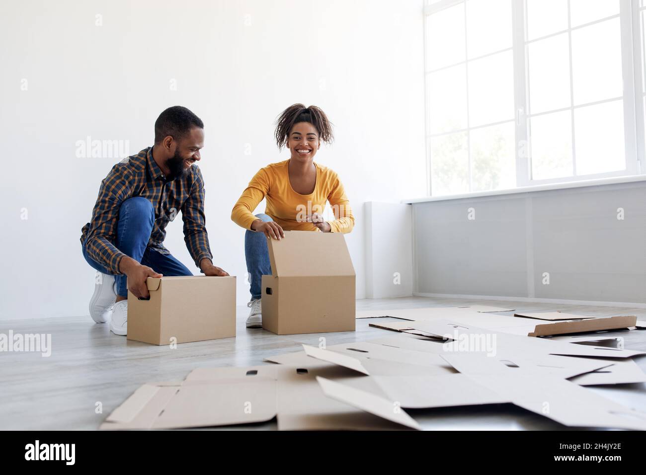 Satisfied smiling millennial african american husband and wife stack ...