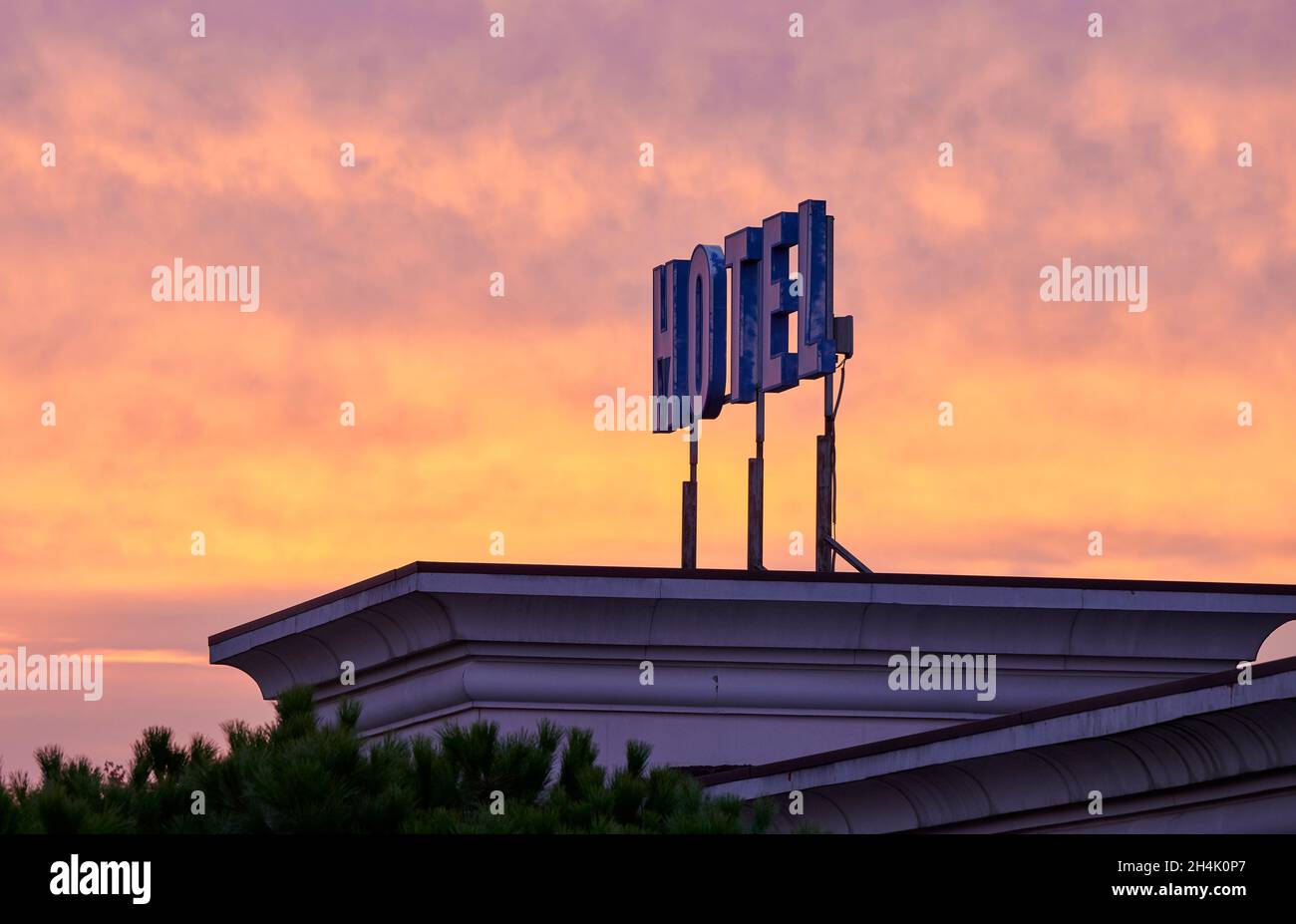 a hotel sign in the light of sunrise Stock Photo - Alamy