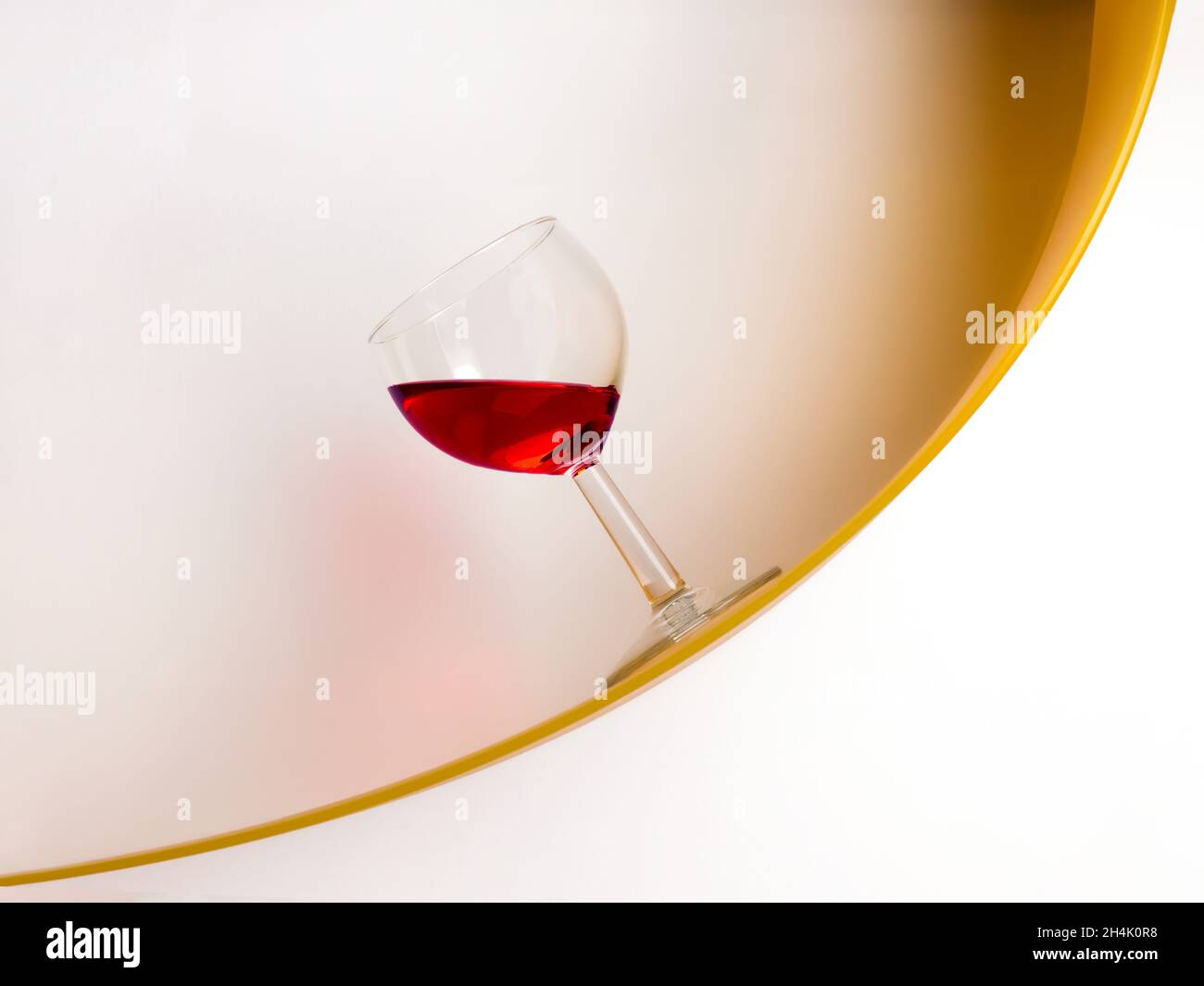 Glass of red wine standing at an angle on a curved shelf Stock Photo ...