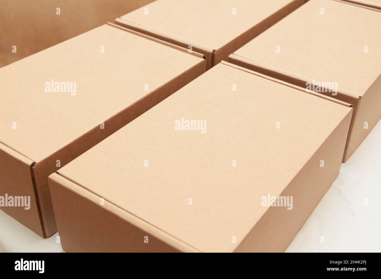 Four cardboard shipping boxes on a table Stock Photo - Alamy