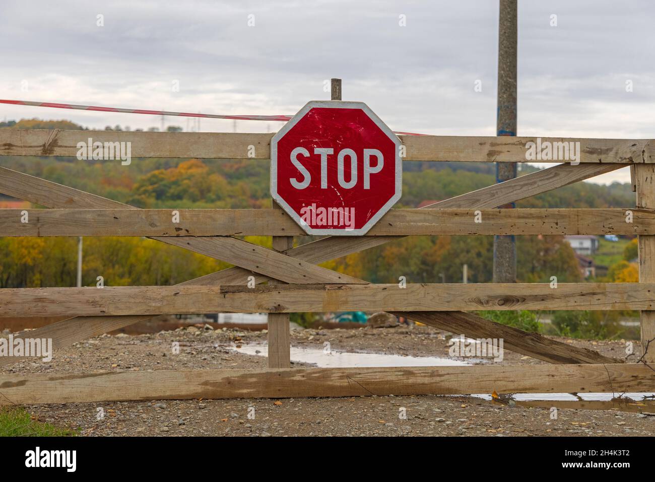 Stop Sign at Wooden Fence Dirt Road Stock Photo - Alamy