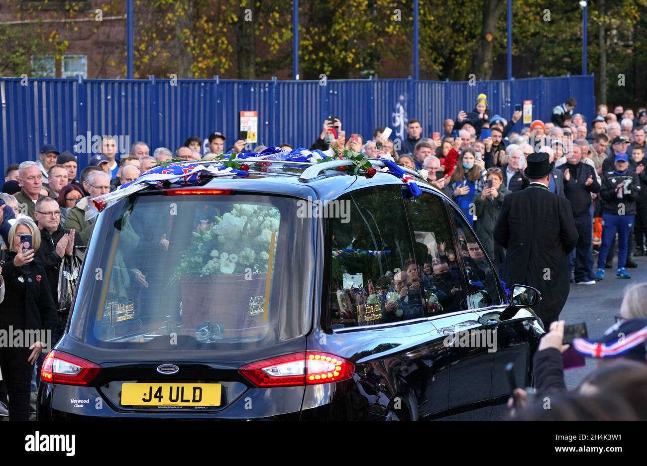 Crowds take photographs as the funeral procession passes Ibrox Stadium ...