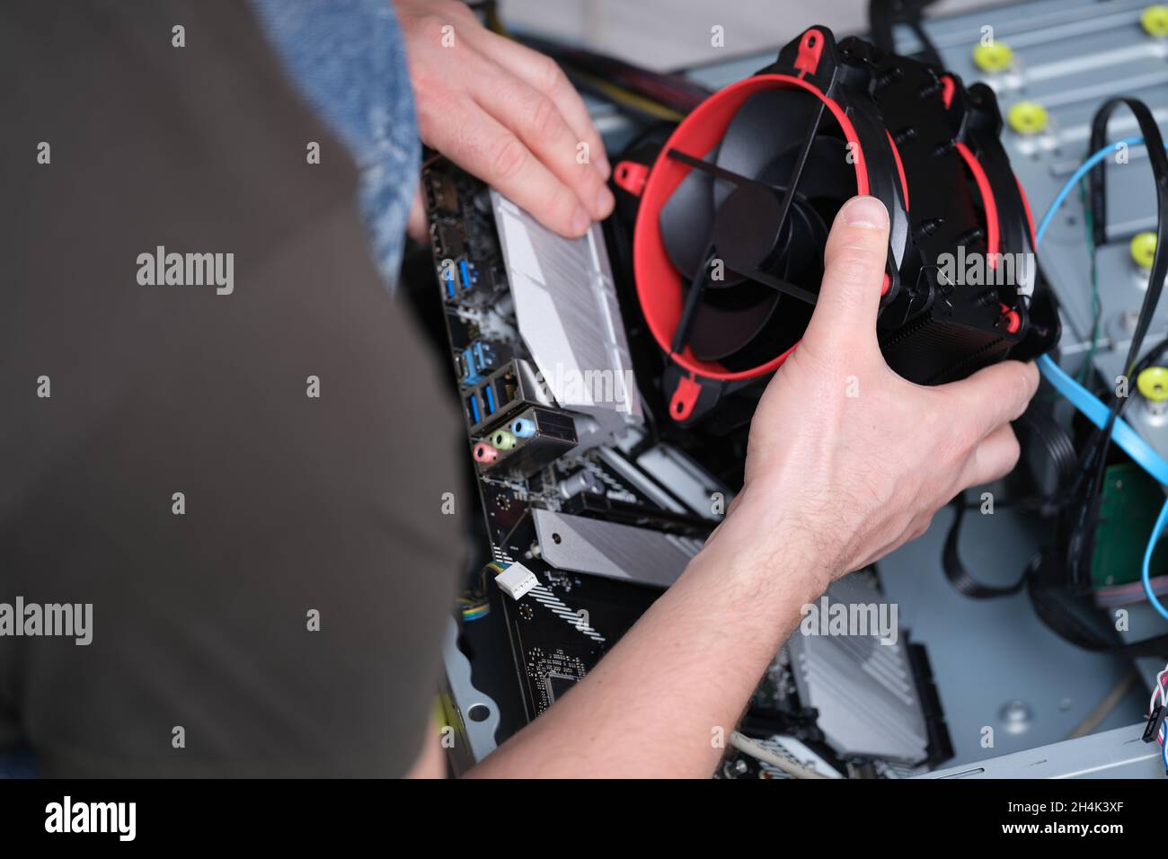 Master repairer holding cooler in front of system unit closeup Stock ...