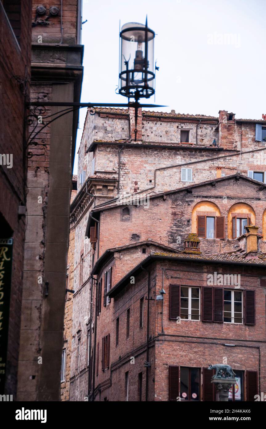 Layered brick townhouses in medieval Siena, Italy Stock Photo - Alamy