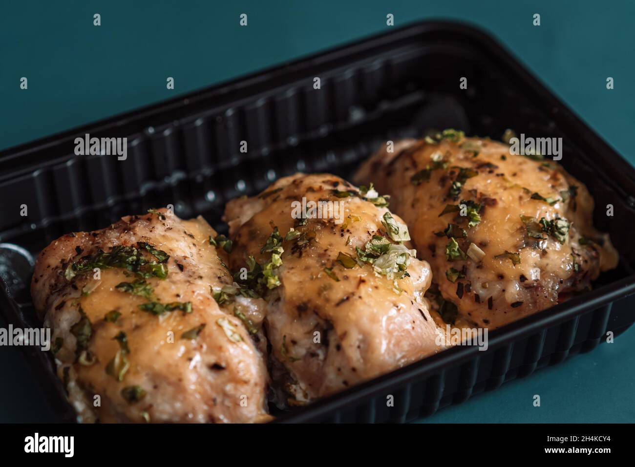 Three chicken meatloafs in black plastic container Stock Photo - Alamy