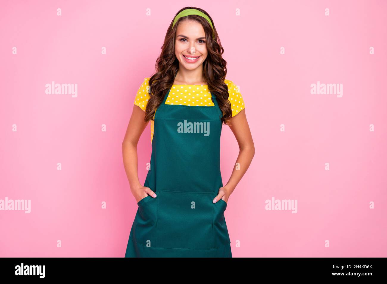 Photo of cute adorable young woman wear green apron smiling isolated ...