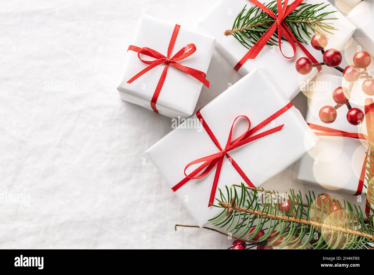 Christmas gift boxes with decorations on white tablecloth Stock Photo ...
