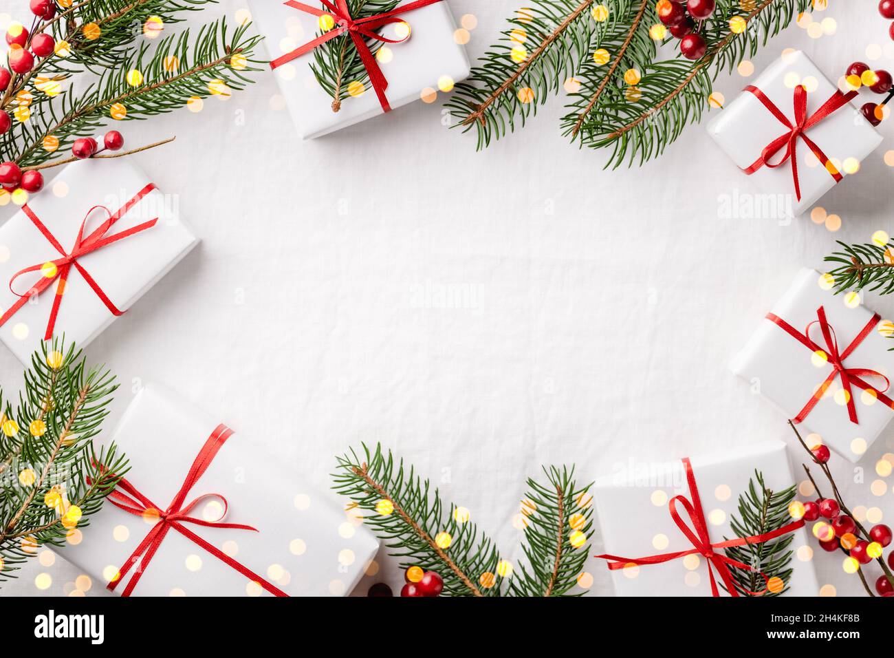 Christmas frame made of gift boxes and fir branches on white tablecloth ...