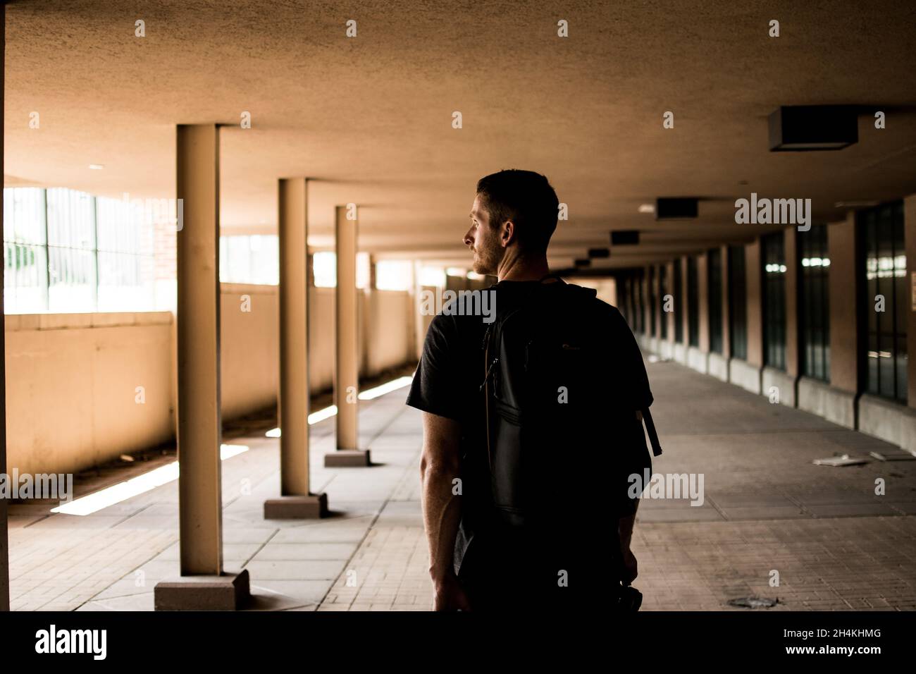 Man walking with backpack Stock Photo - Alamy