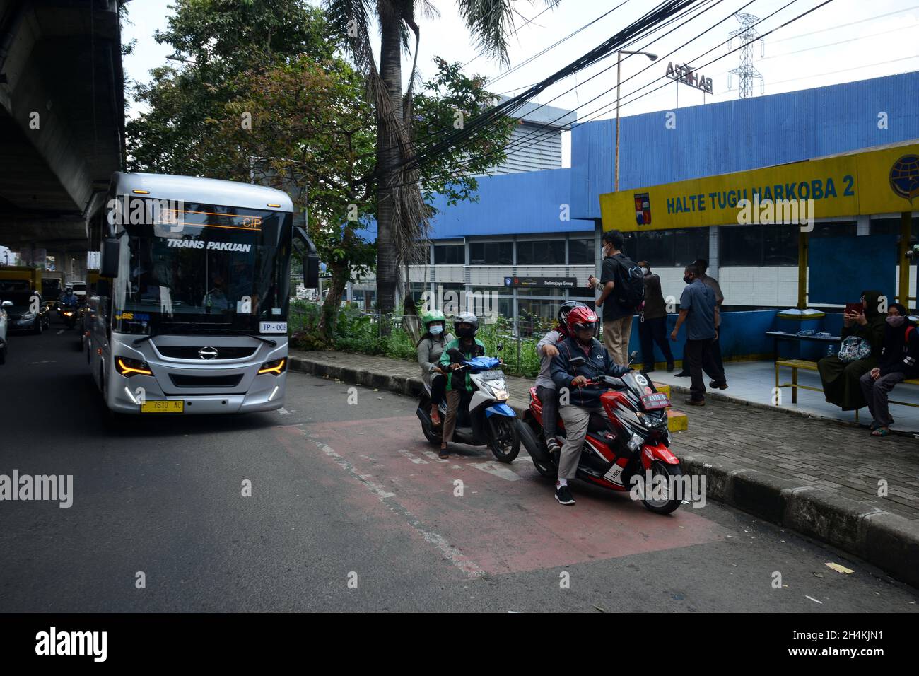 A bus Kita Trans Pakuan drives on a road in Bogor, West Java, Indonesia ...