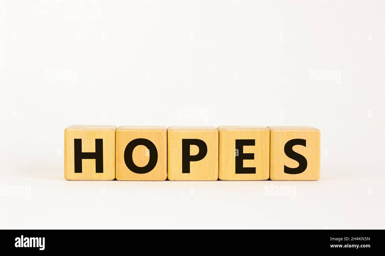 Hopes symbol. The concept word 'hopes' on wooden cubes. Beautiful white ...