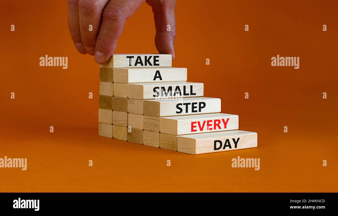 Take a small step every day symbol. Wooden blocks with words Take a ...