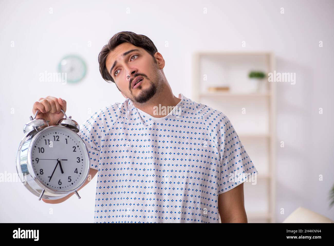 Young patient in time management concept Stock Photo - Alamy