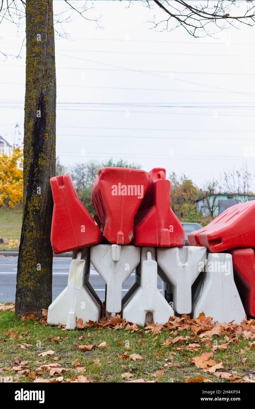 Red and white plastic road barriers. Construction props Stock Photo - Alamy