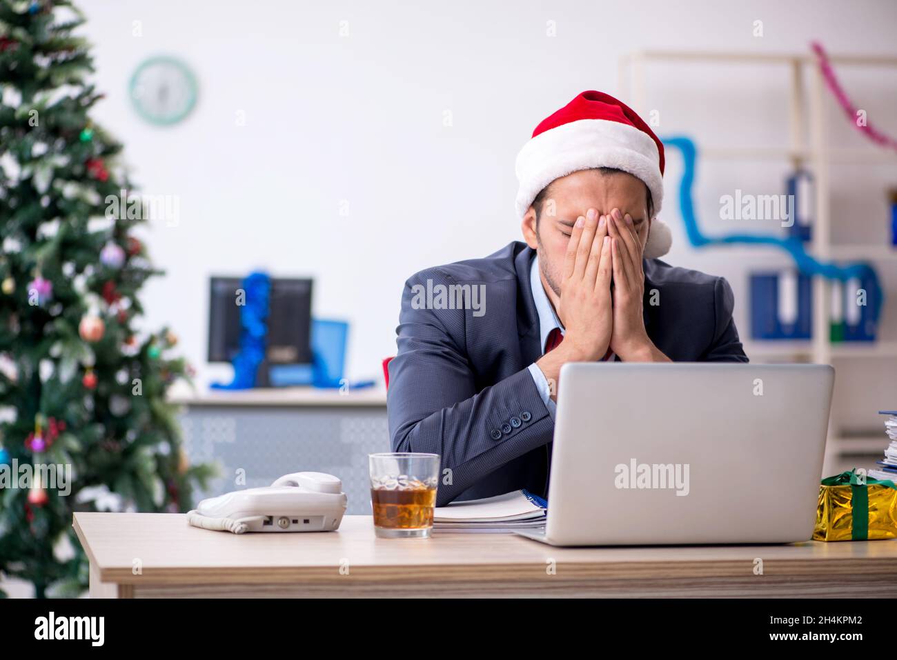 Young employee celebrating Christmas in the office Stock Photo - Alamy