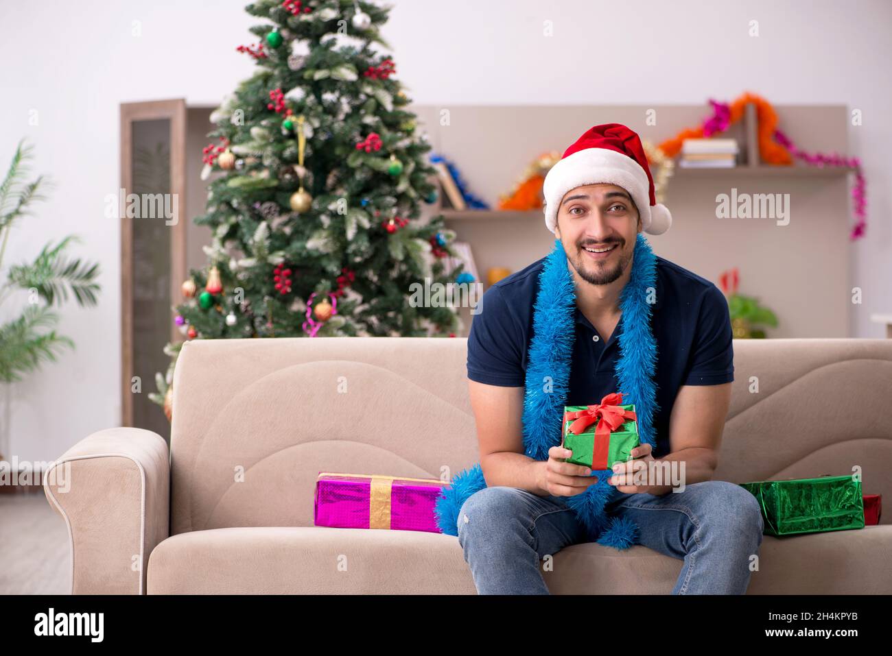 Young man celebrating New year at home alone Stock Photo - Alamy