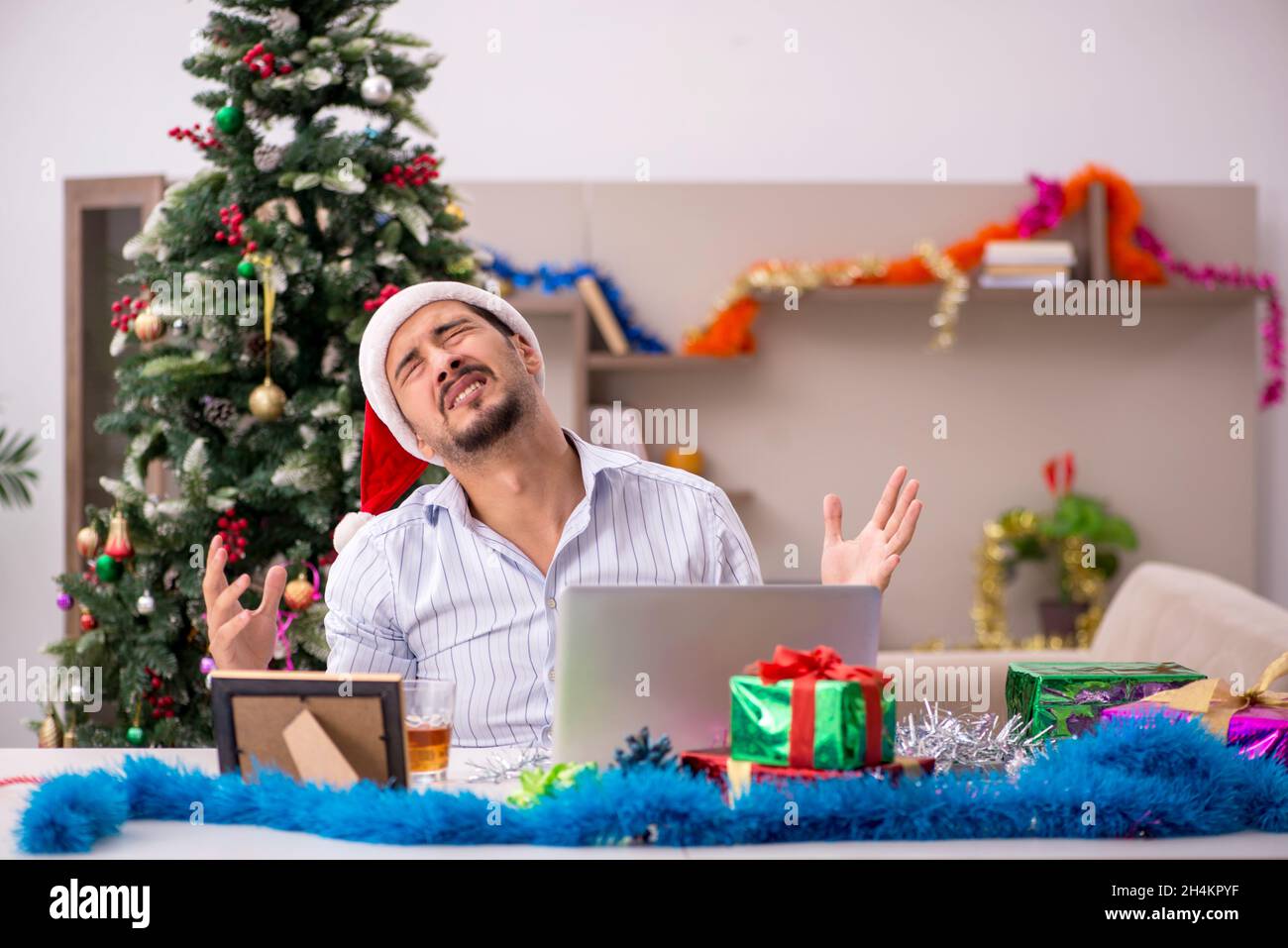 Young man celebrating New year at home alone Stock Photo - Alamy