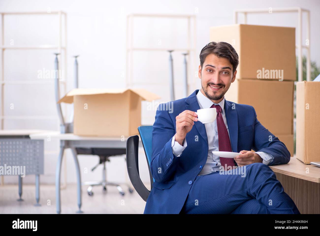 Young employee in relocation concept Stock Photo - Alamy