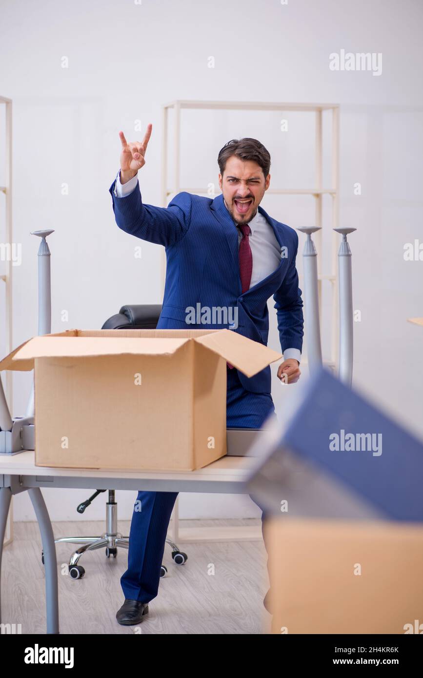 Young employee in relocation concept Stock Photo - Alamy