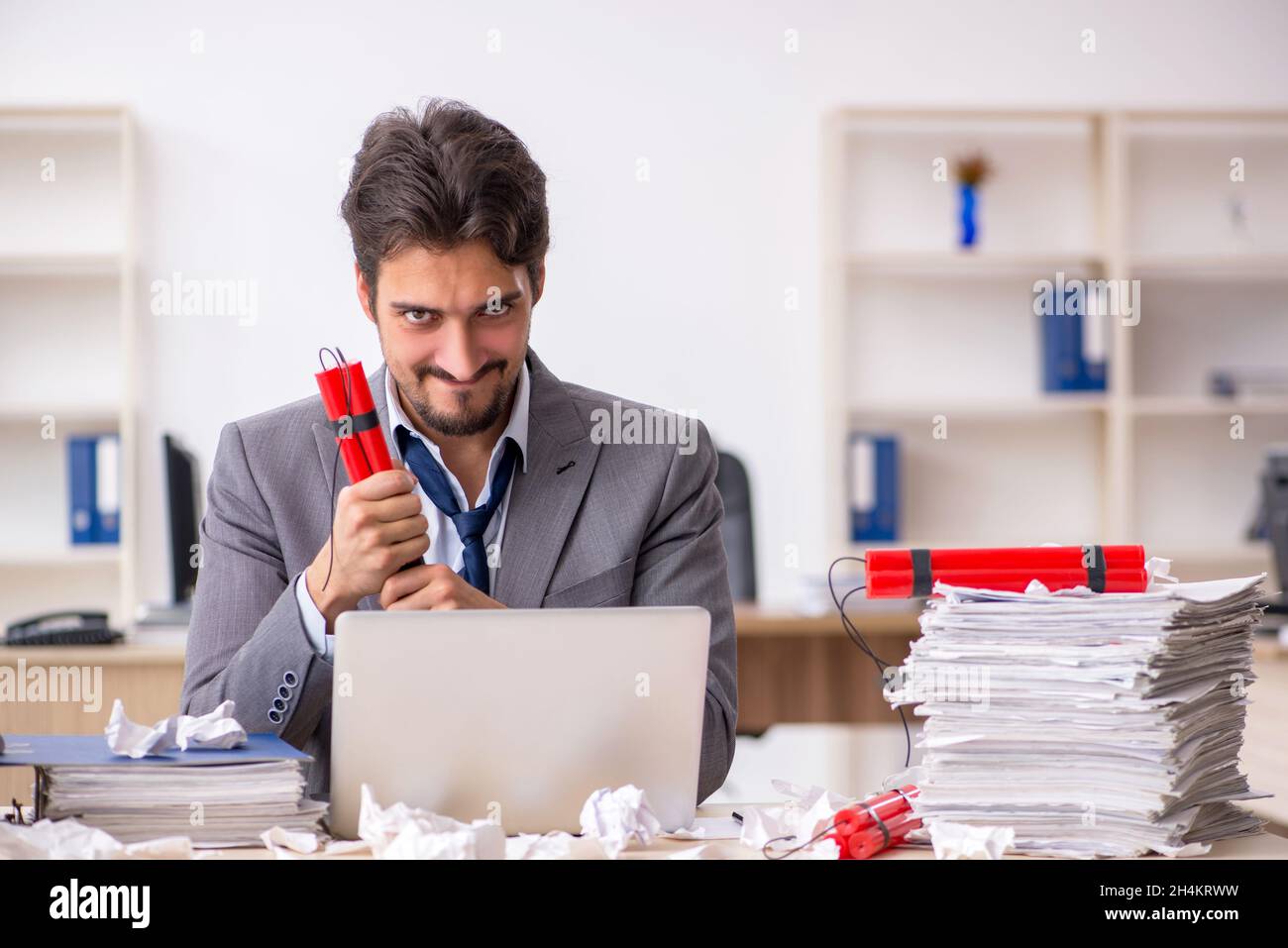Young employee and too much work in the office Stock Photo - Alamy