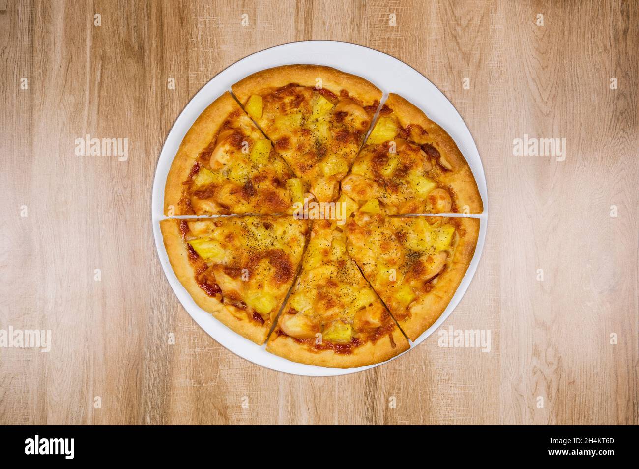Top view of delicious and crispy hawaiian pizza topping with mozzarella ...