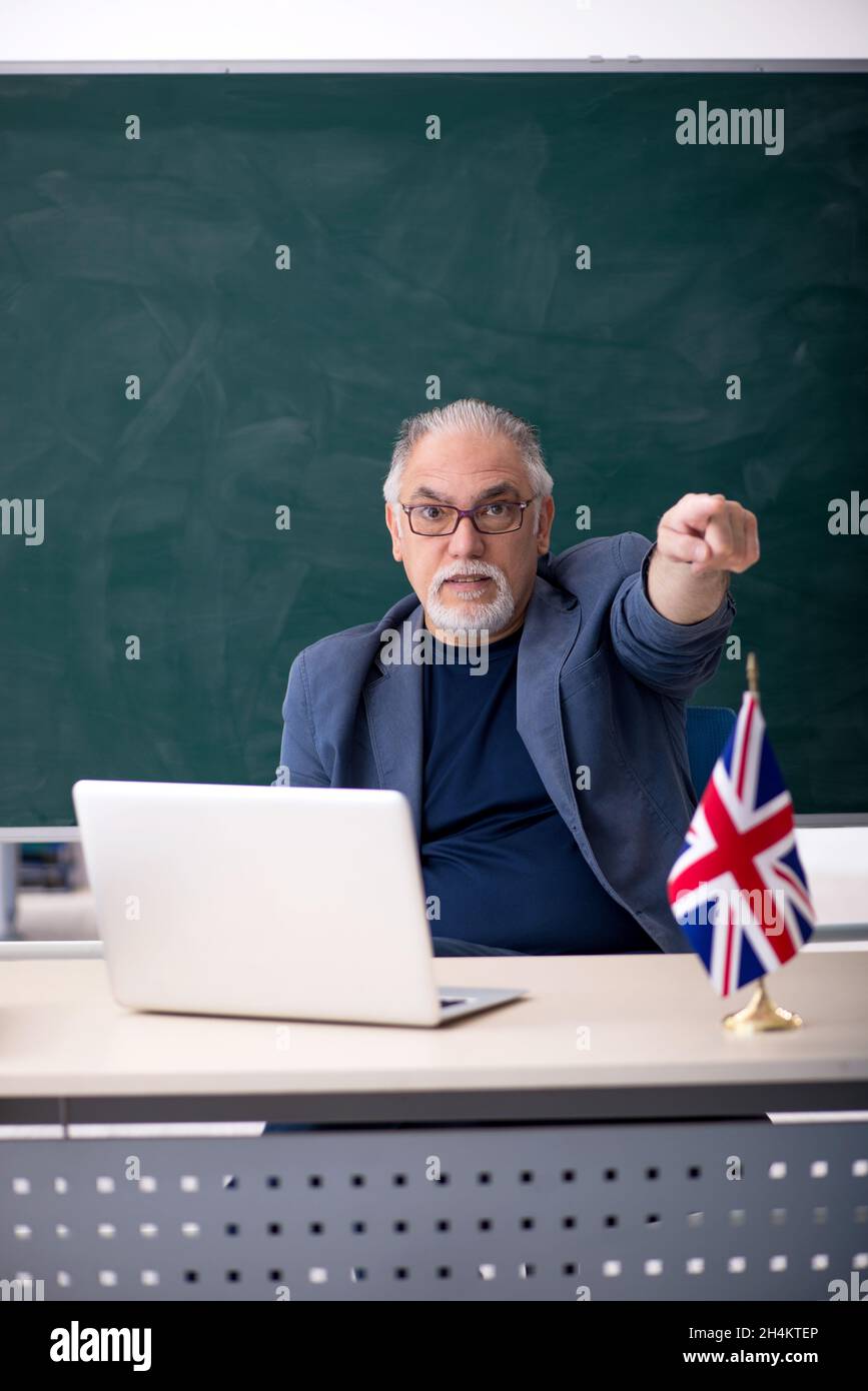 Old english language teacher in the classroom Stock Photo - Alamy
