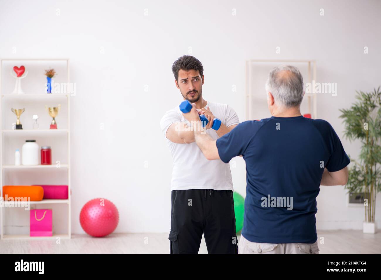Fitness instructor showing stretching exercises hi-res stock ...