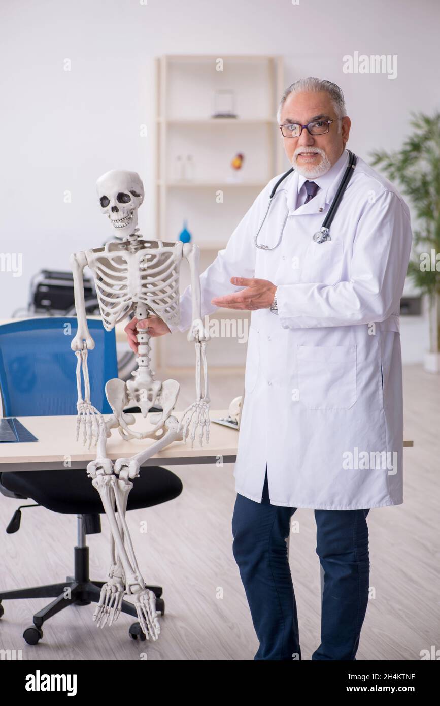 Old doctor demonstrating human skeleton Stock Photo - Alamy