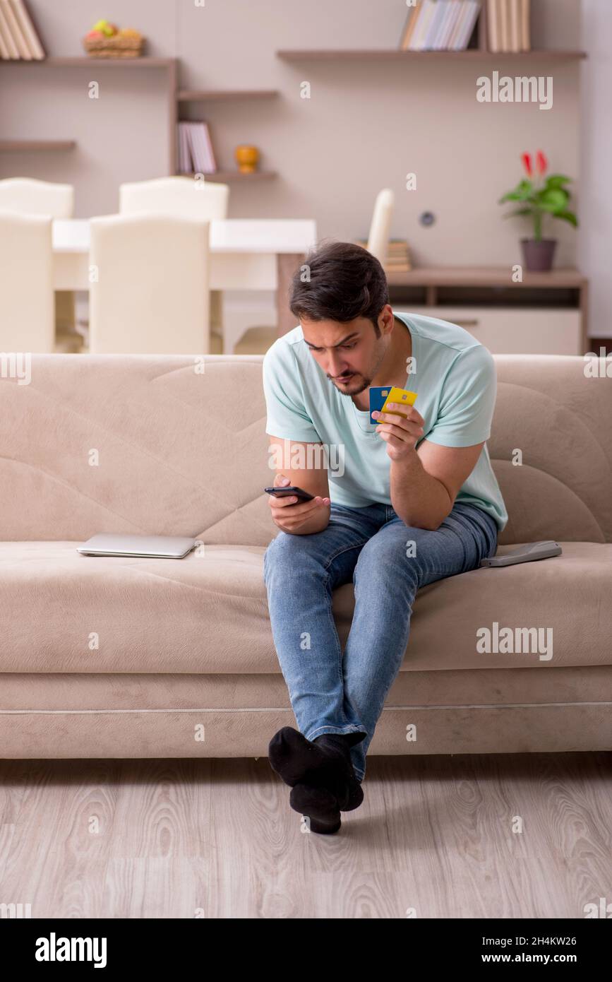 Young freelancer in e-commerce concept Stock Photo - Alamy