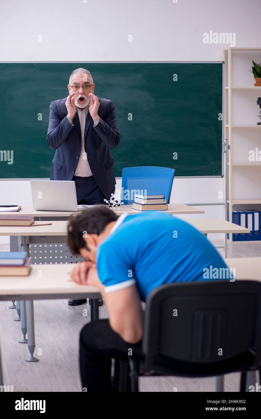 Young student sleeping in the classroom Stock Photo - Alamy