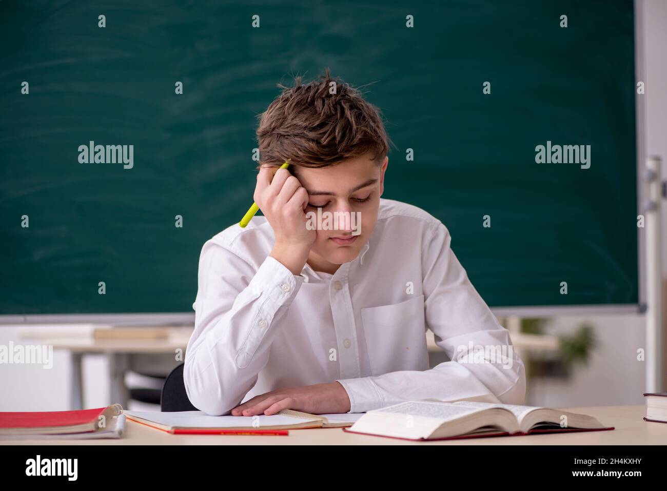 Male pupil sitting in the classrom Stock Photo - Alamy
