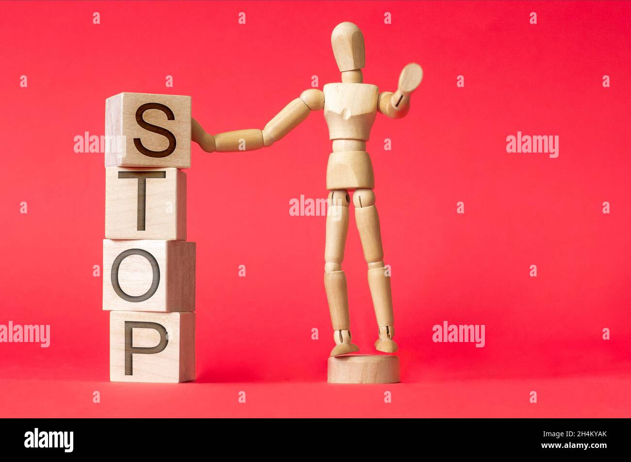 Wooden letters spelling stop with woodenman on a red background Stock ...