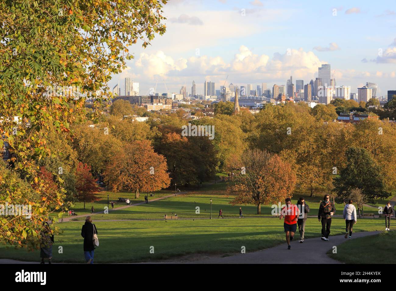 Autumn colours and sunshine on Primrose Hill with the City beyond, in ...