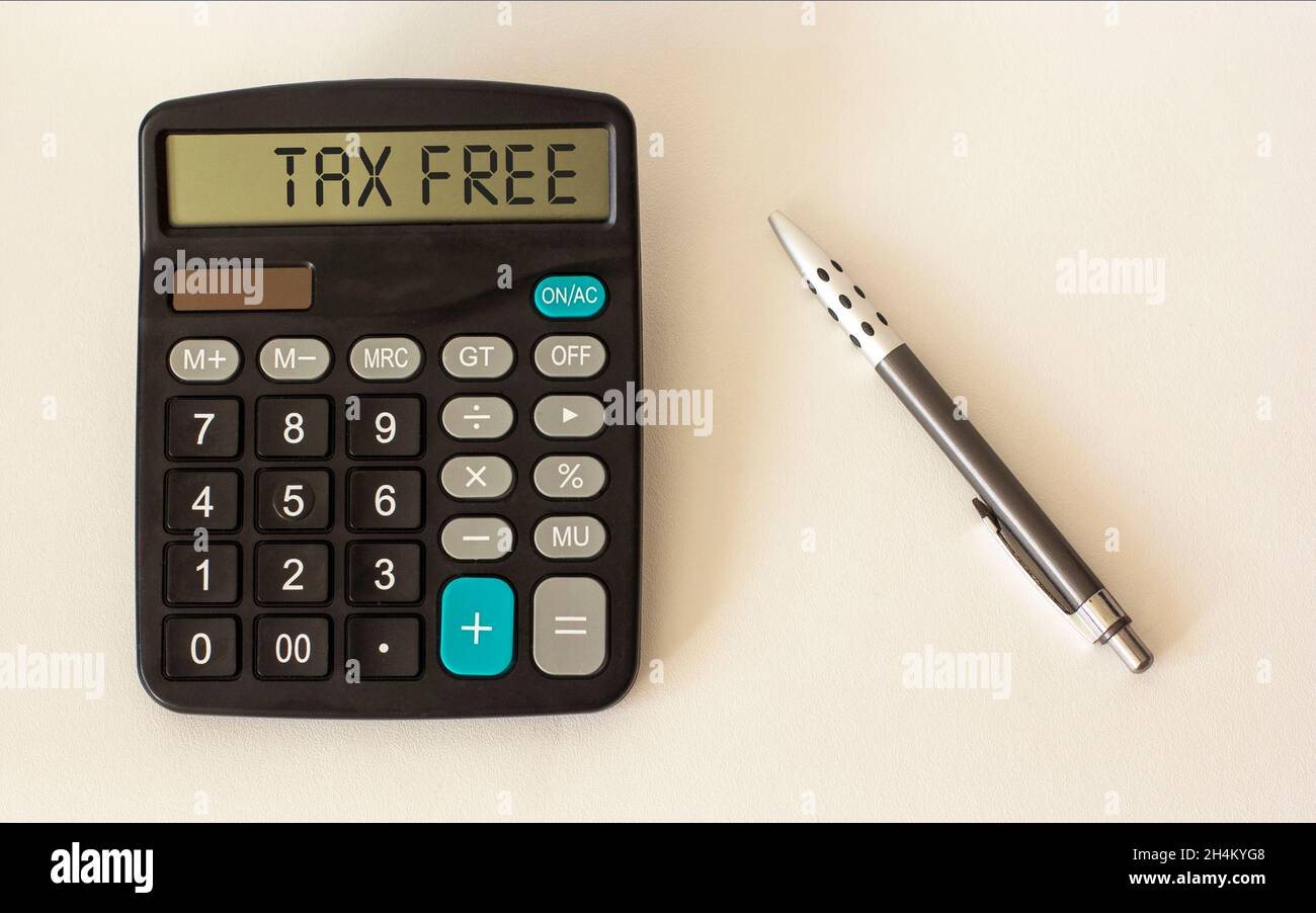 Calculator with text Tax Free on display and white background with pen ...