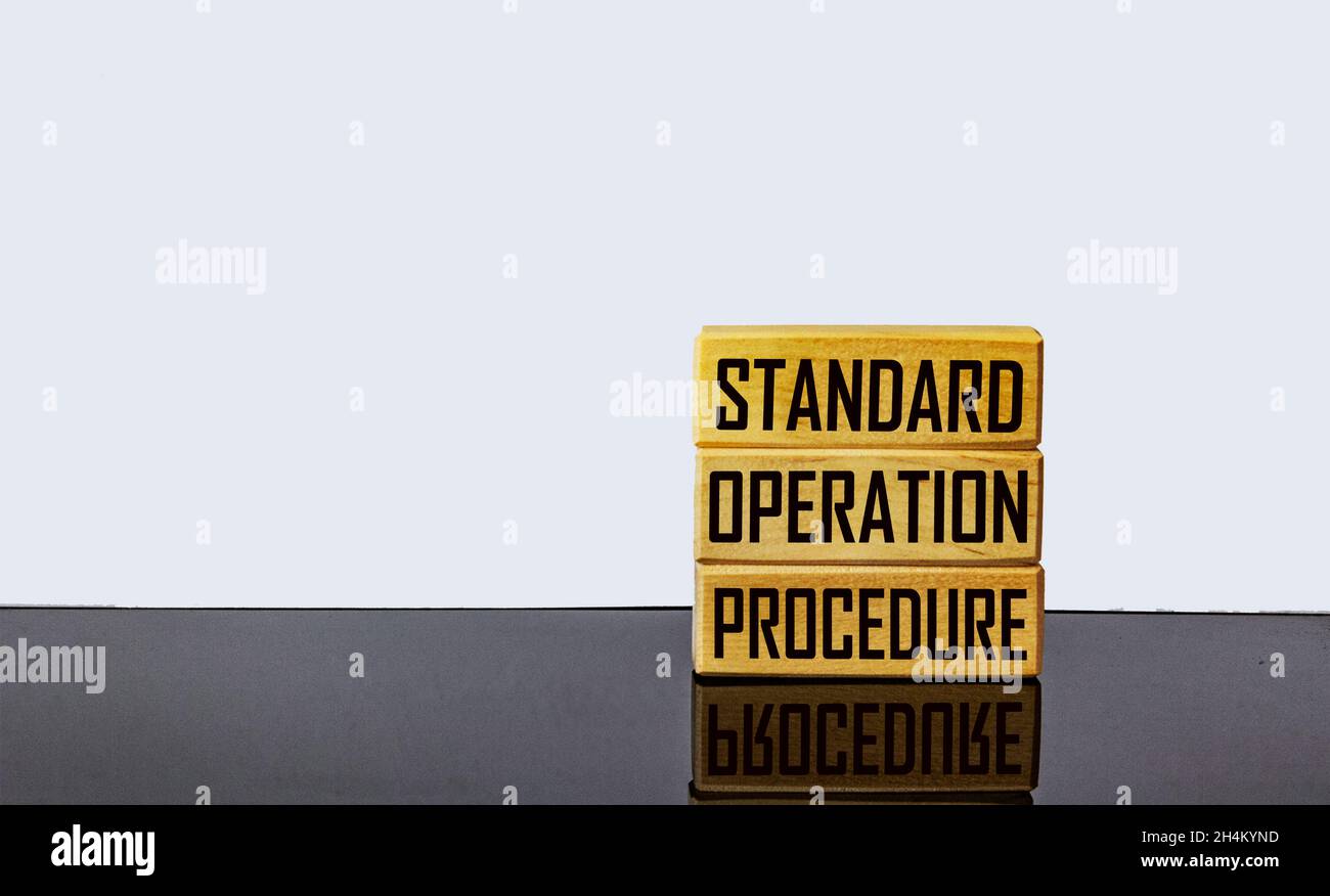 A text symbol showing standard operating procedure. Text on wooden ...
