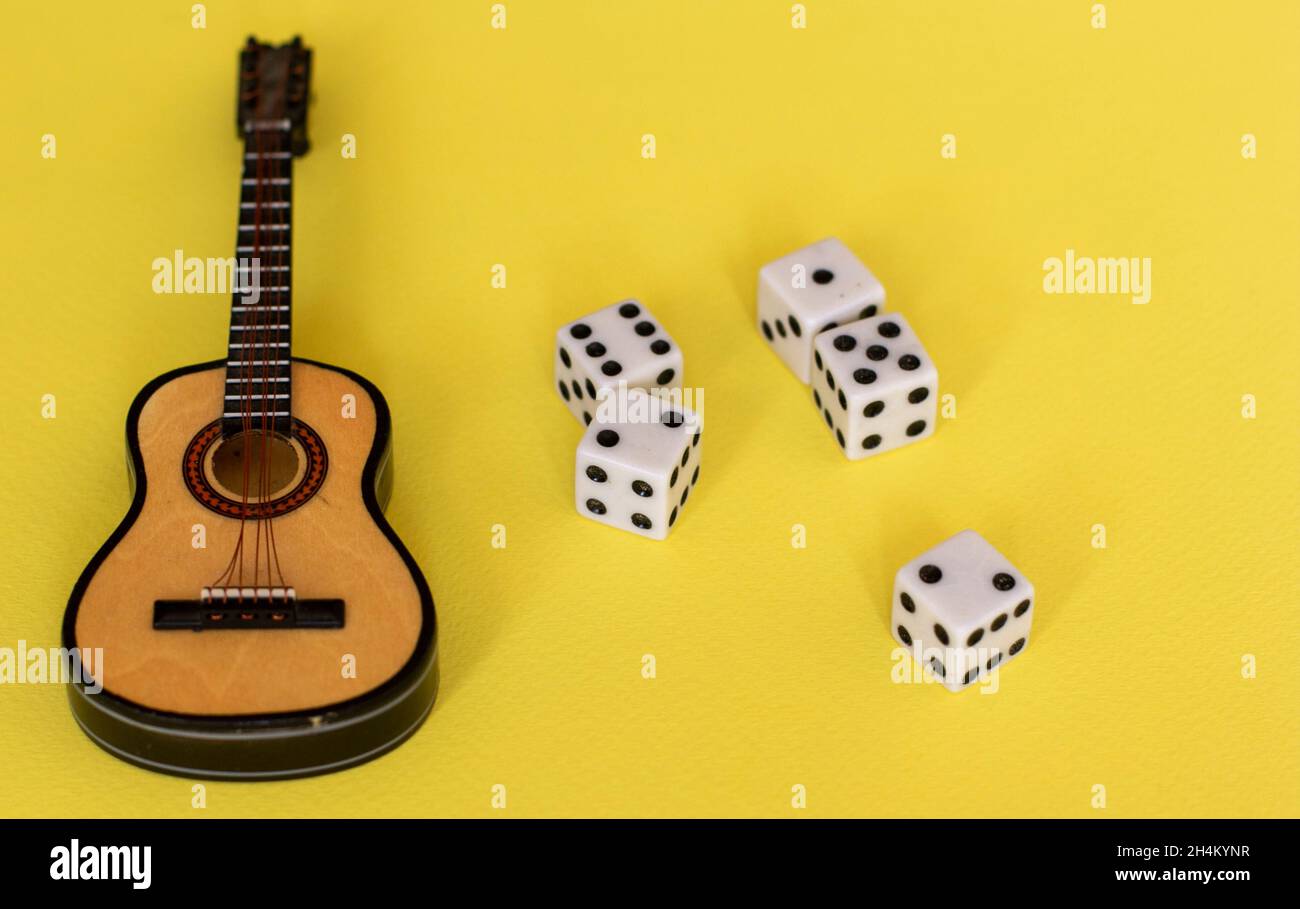 Guitar on a yellow background , dice Stock Photo - Alamy