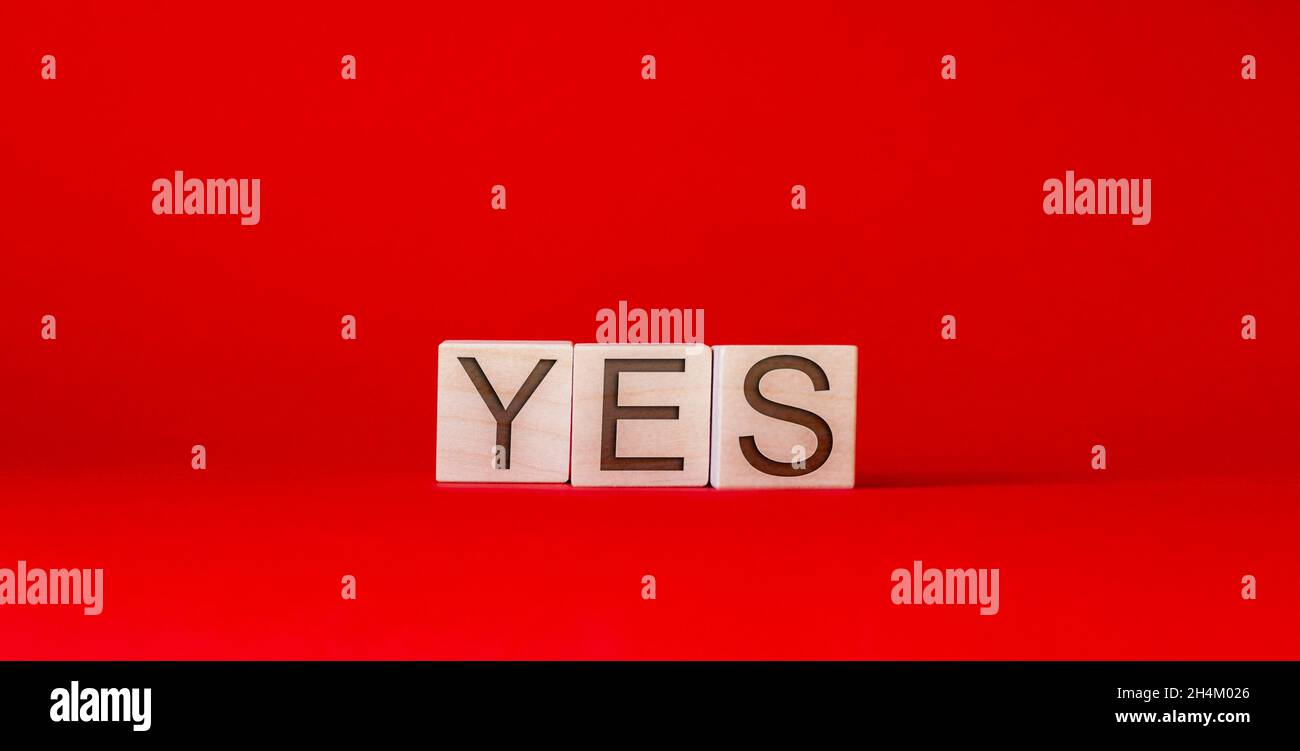 text yes written on wooden blocks, on a red background Stock Photo - Alamy