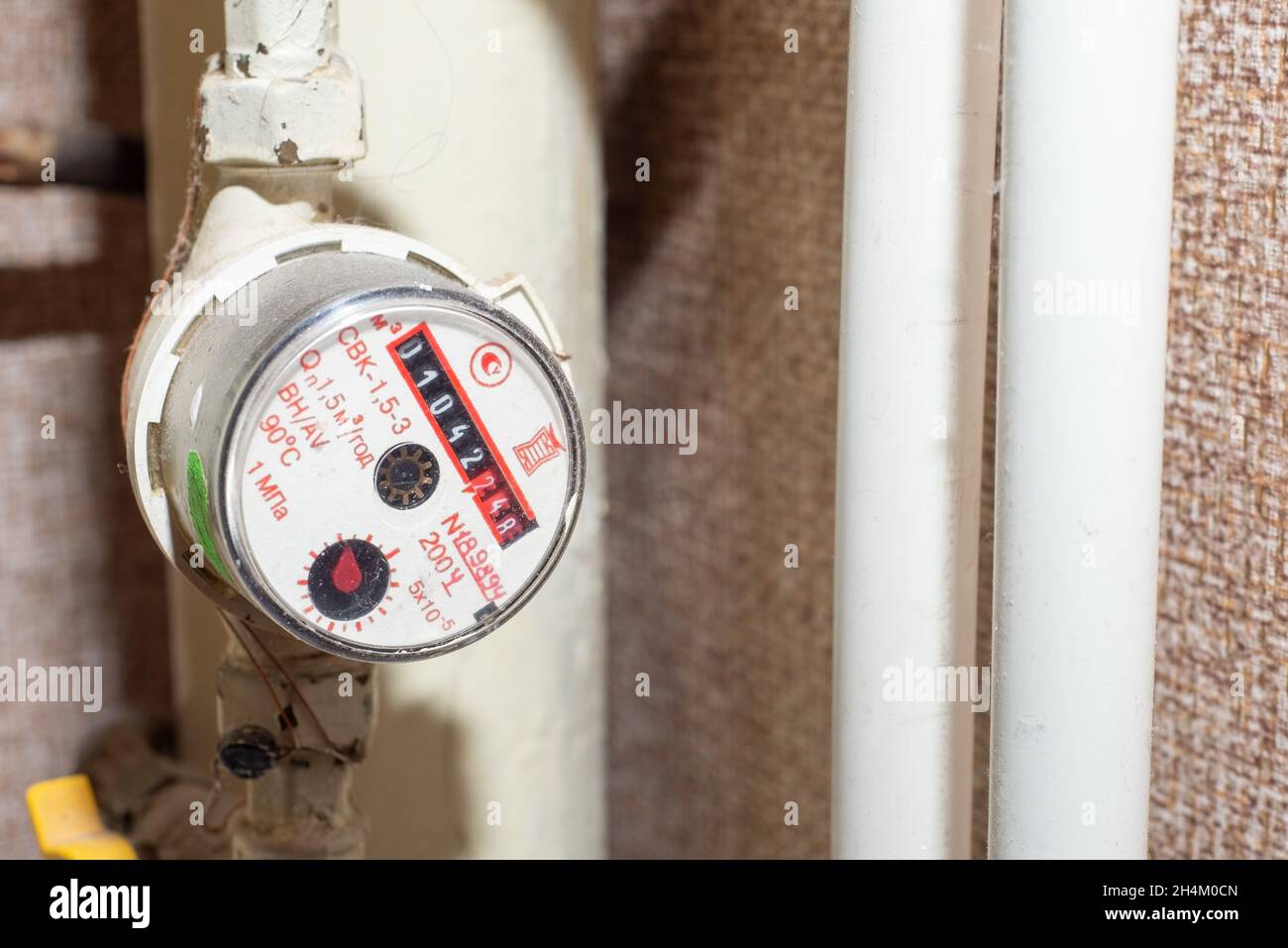 Industrial pressure meter - barometer and water pipes in the background ...