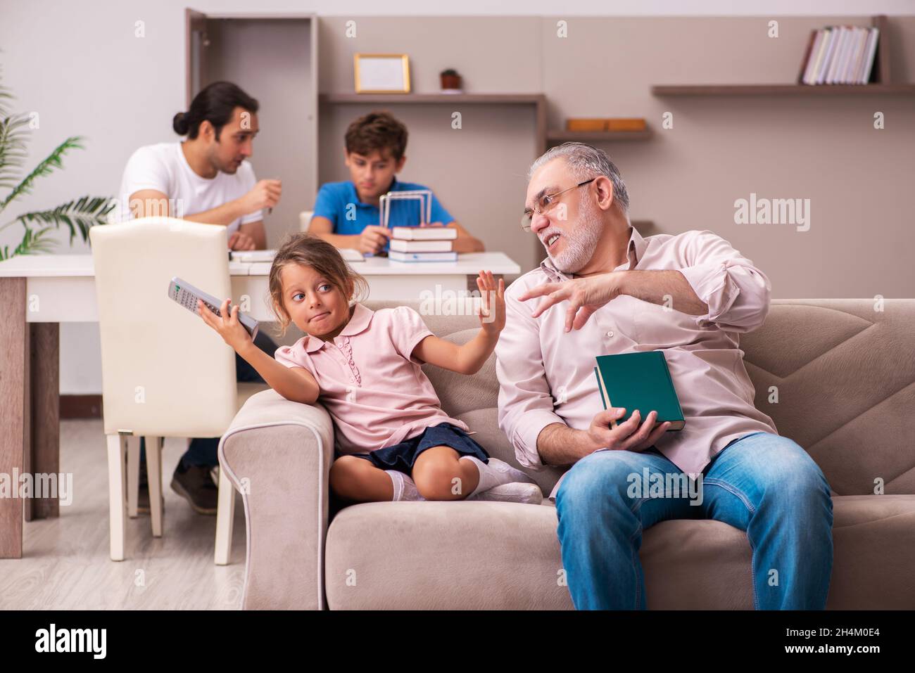 Three generations at home in early development concept Stock Photo - Alamy