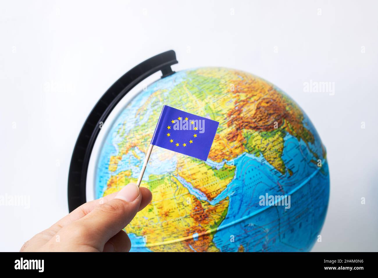 EU flag on a background of a globe with a map Stock Photo - Alamy