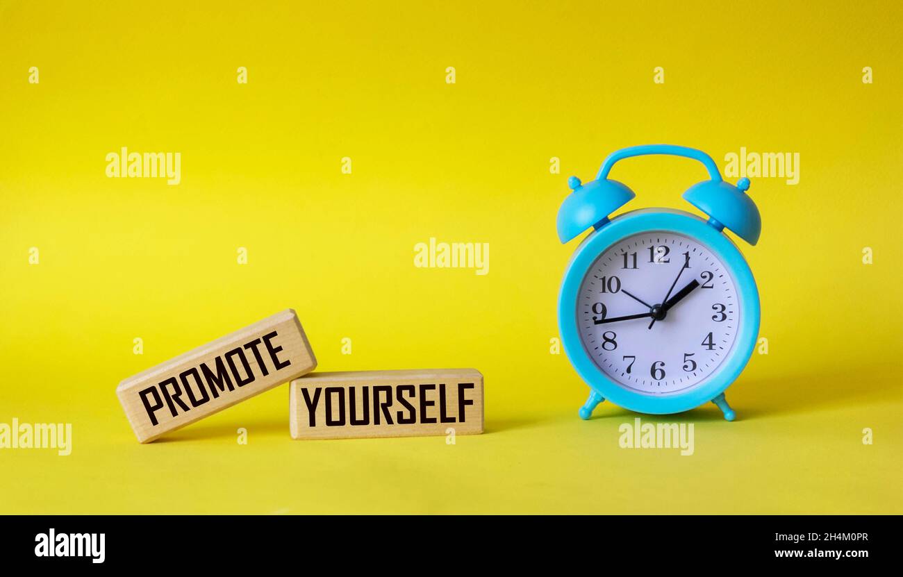 Promote Yourself text written on wooden blocks and yellow background ...