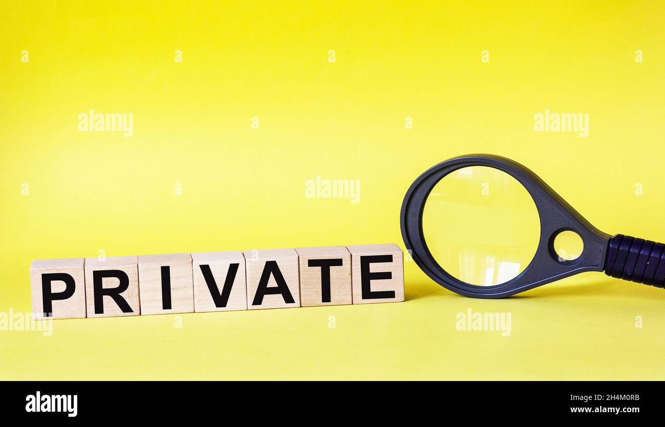 Concept word PRIVATE on wooden cubes on yellow background. Business ...