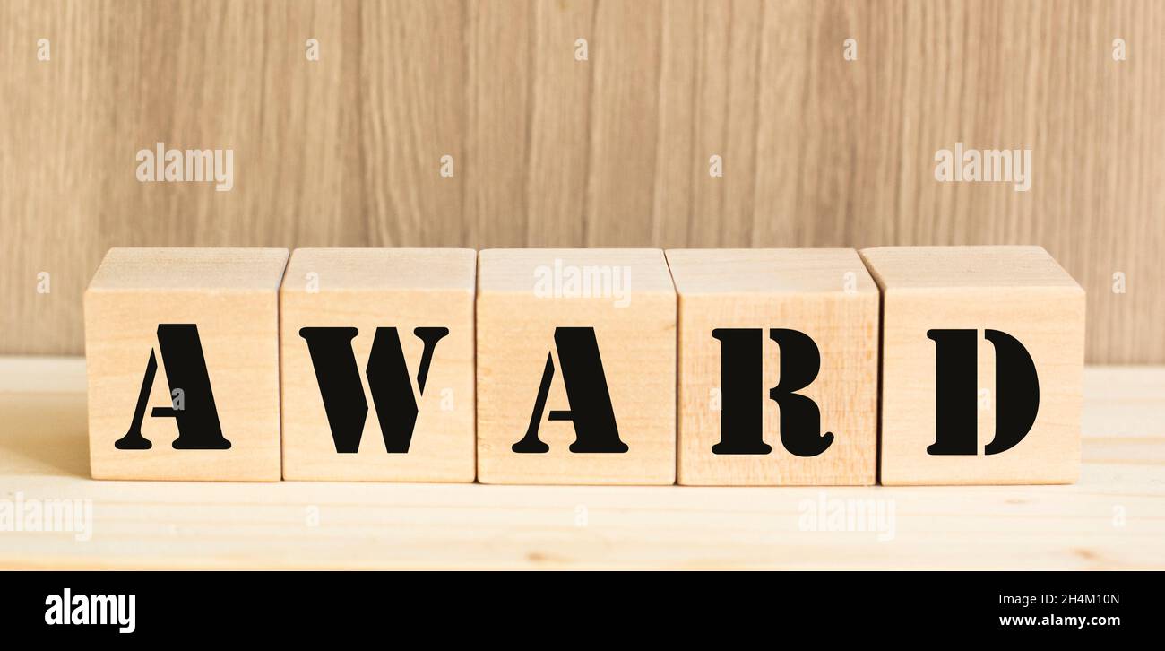 AWARDS word written on wood block. AWARDS text on wooden table for your ...