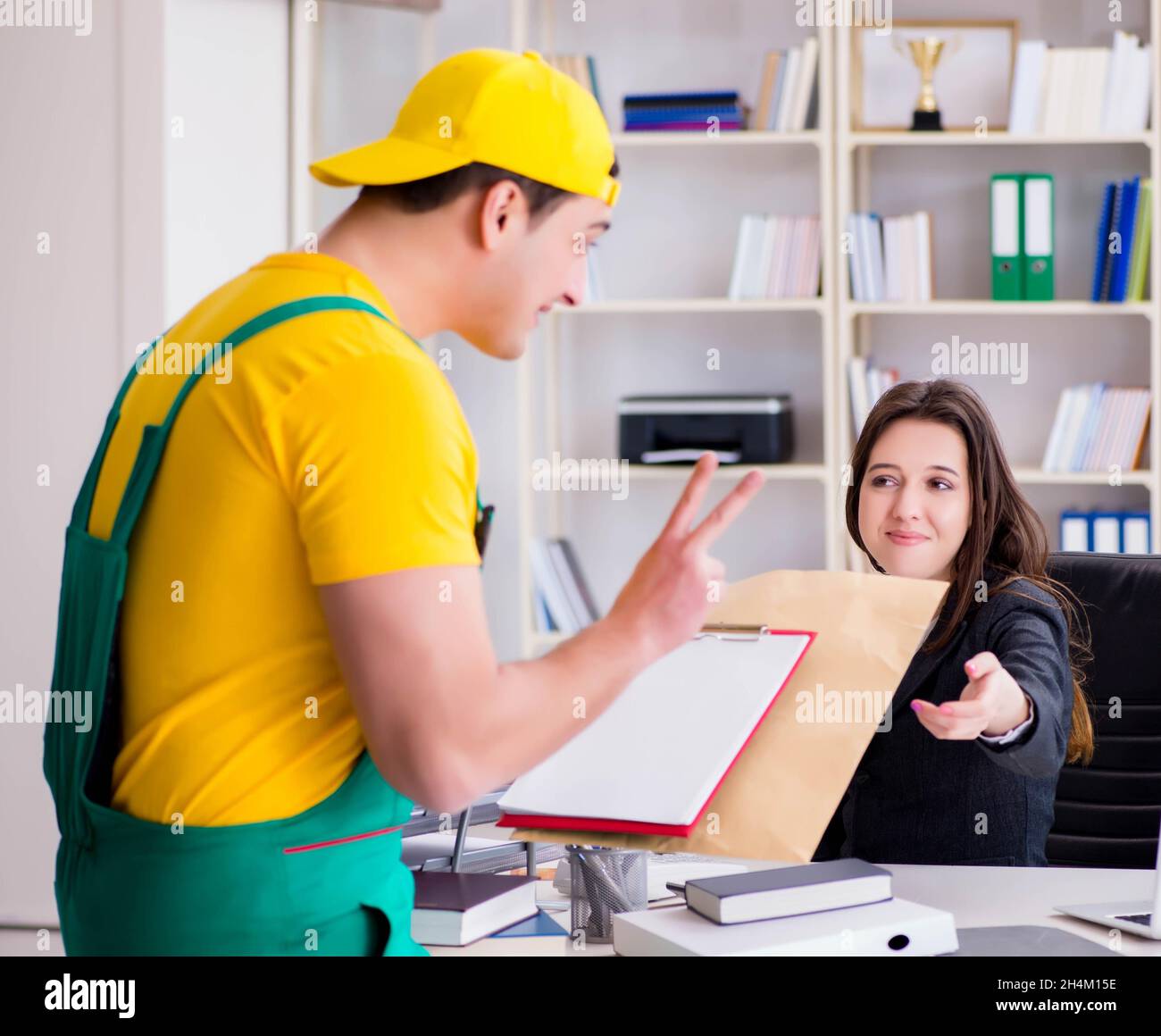 The postman delivering parcel to the office Stock Photo - Alamy