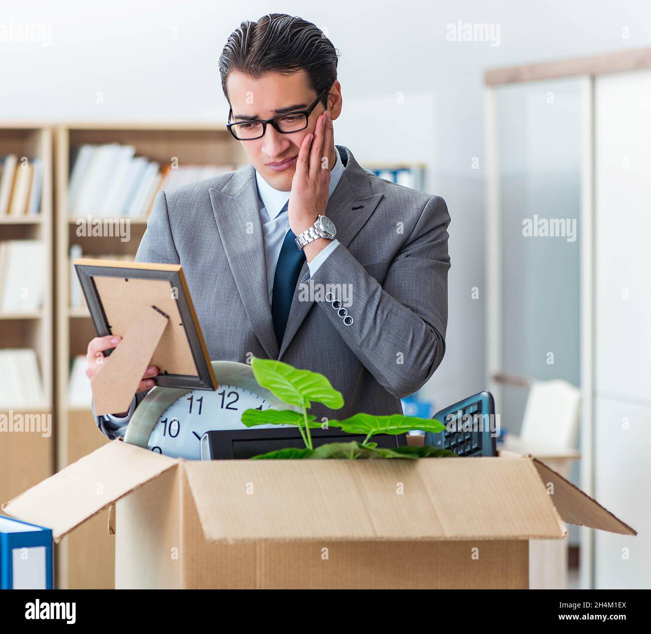 The man moving office with box and his belongings Stock Photo - Alamy
