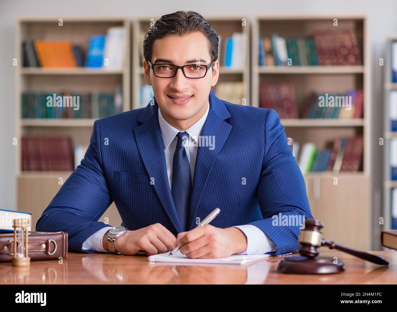 The handsome judge with gavel sitting in courtroom Stock Photo - Alamy