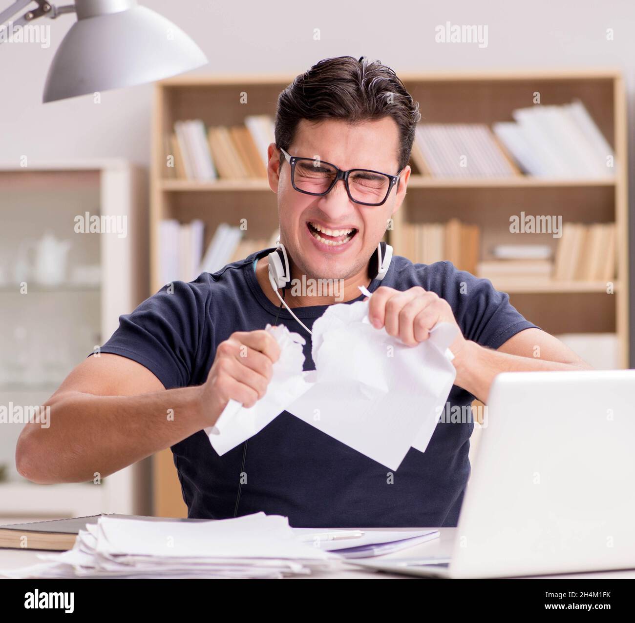 The angry man tearing apart his paperwork due to stress Stock Photo - Alamy